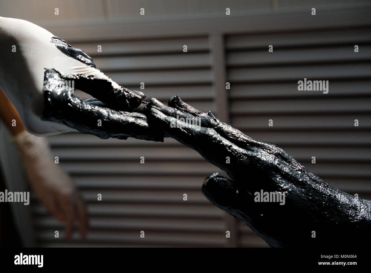 woman getting spa treatment in salon. Female patient having clay body ...