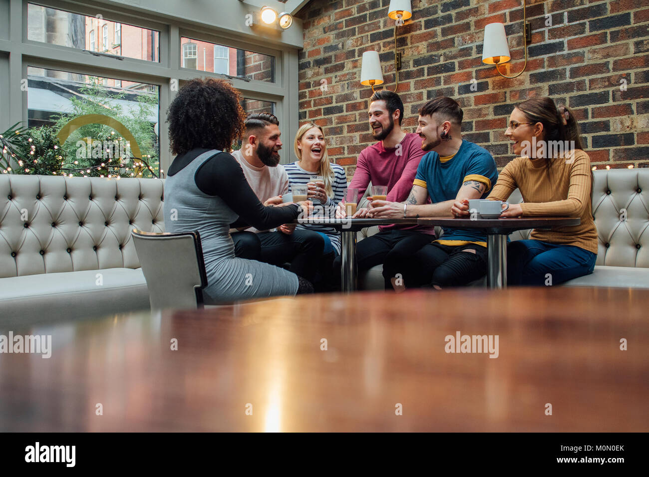 Group of friends are socialising over coffee in a bar/restaurant Stock ...