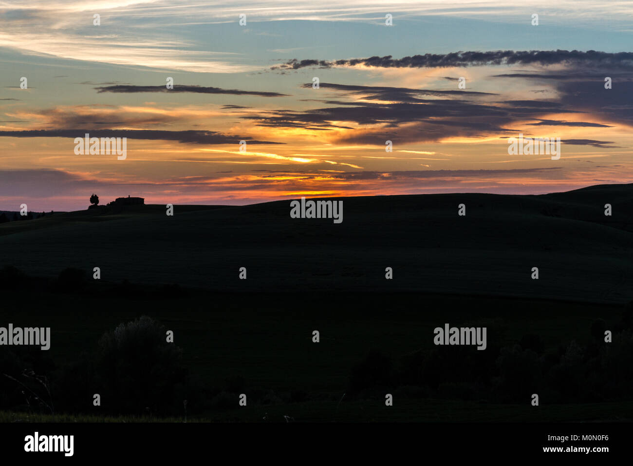 A Beautiful Sunset With A Country House In The Background Stock Photo ...