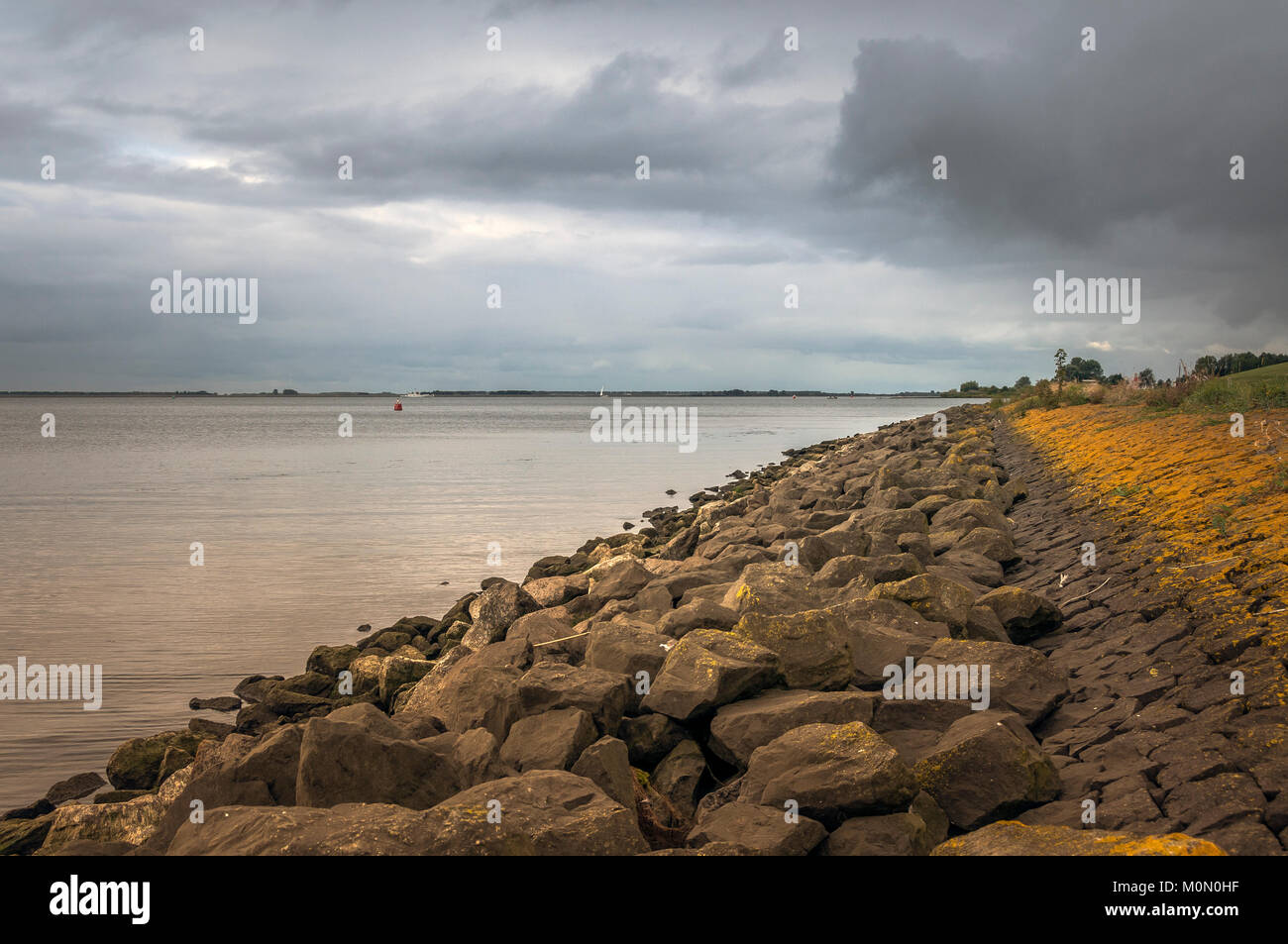 dutch coastline with rocks for dike protection Stock Photo - Alamy