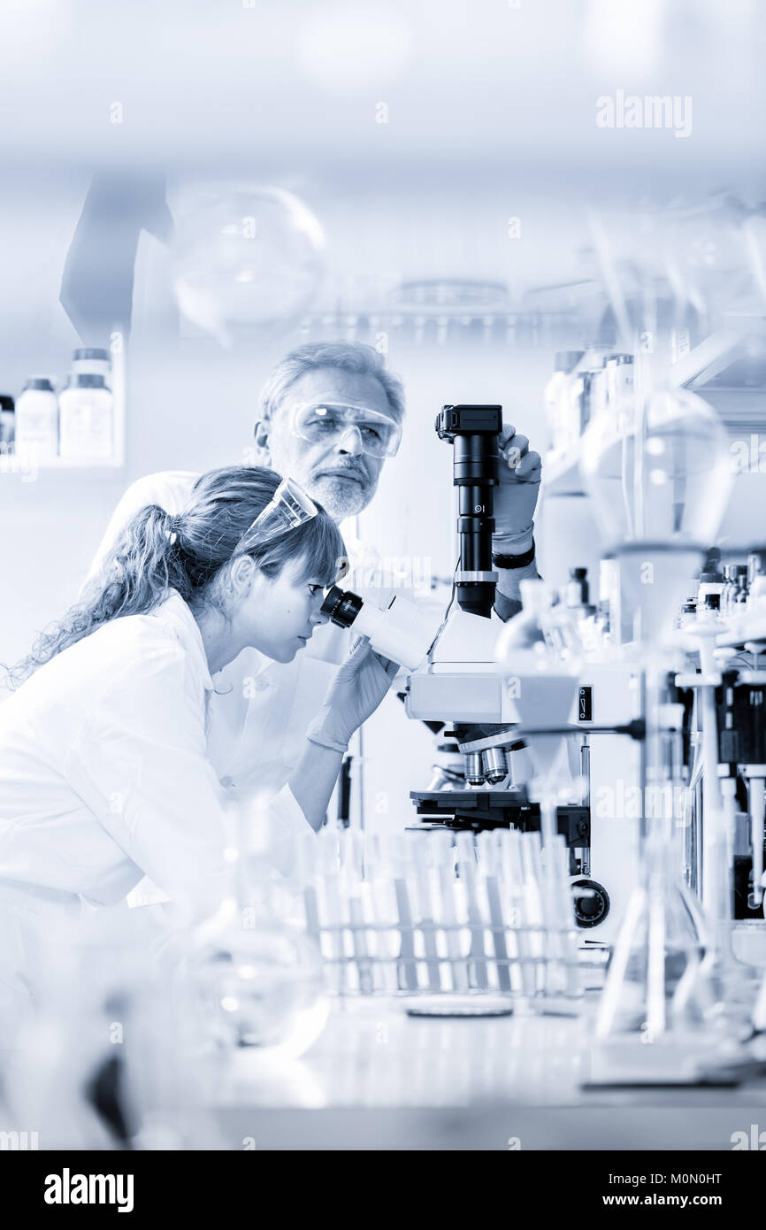 Health care researchers microscoping in scientific laboratory Stock ...