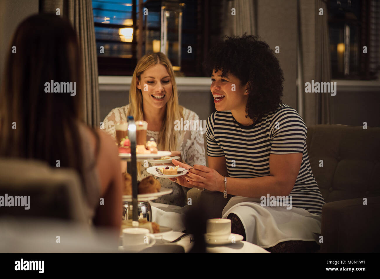 Women are socialising over an afternoon tea Stock Photo - Alamy