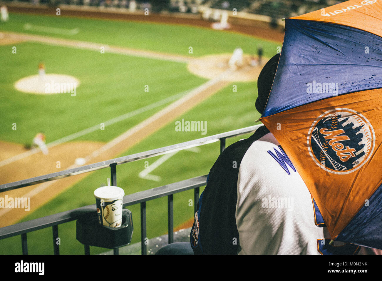A lonely fan of the American baseball team Mets is sitting with an ...