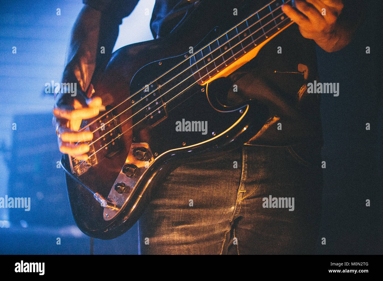 A bass player performs live on stage with his electric bass. Denmark ...