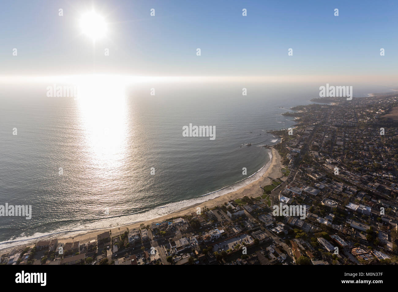 Aerial view of afternoon sun and pacific ocean fog above scenic Laguna ...