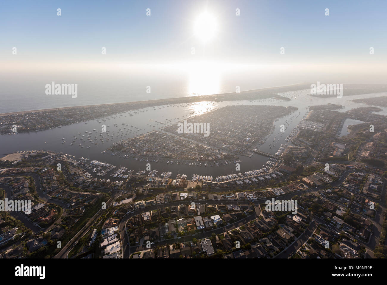 Aerial view of afternoon sun and coastal fog over Balboa Bay and ...