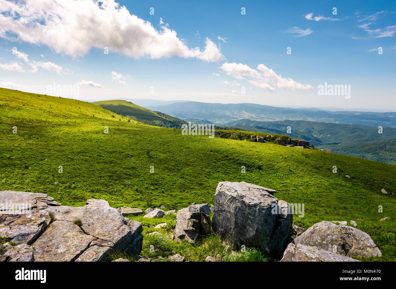 grassy slopes with huge rocks. beautiful mountainous landscape in ...