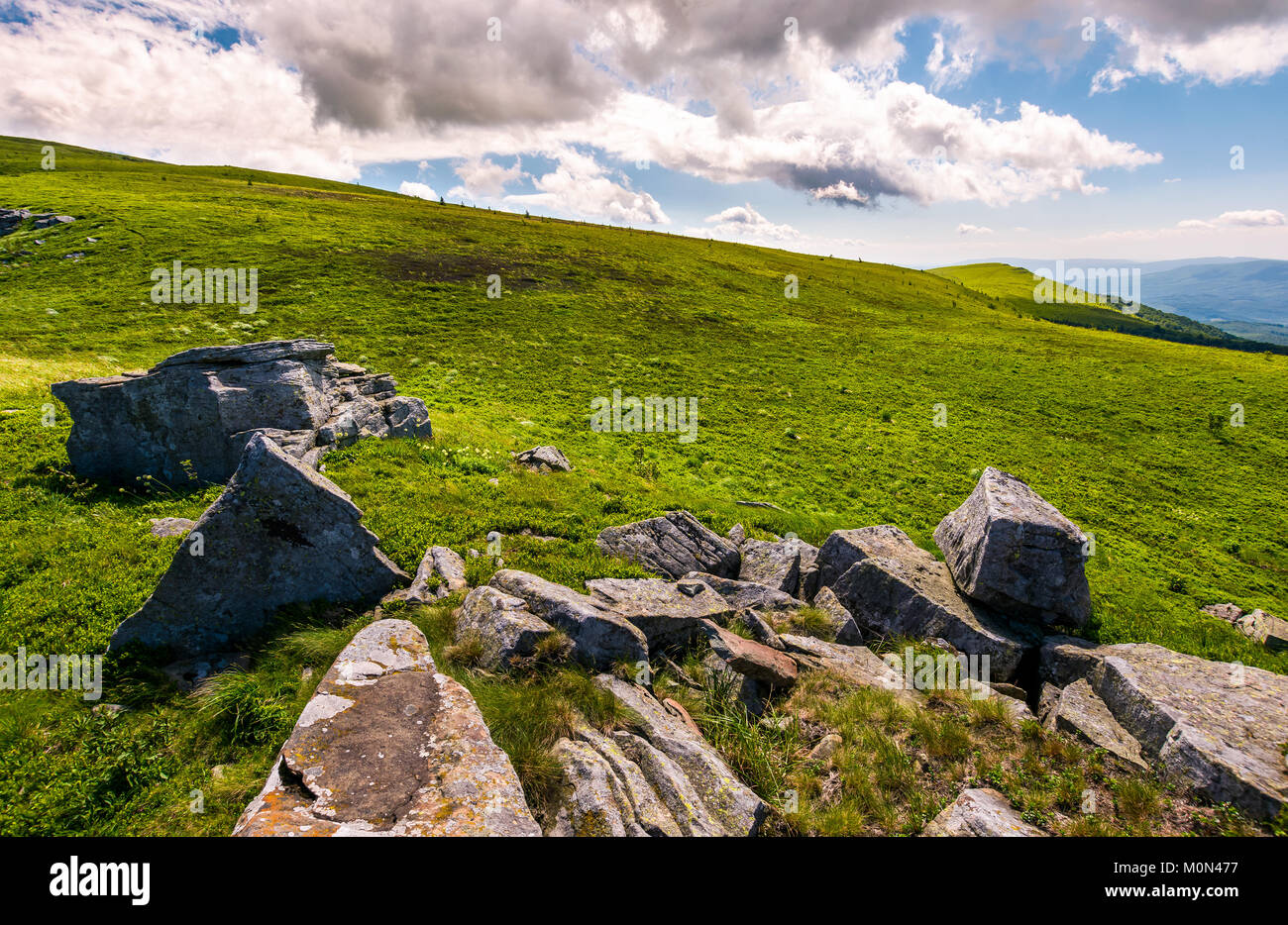 grassy slopes with huge rocks. beautiful mountainous landscape in ...