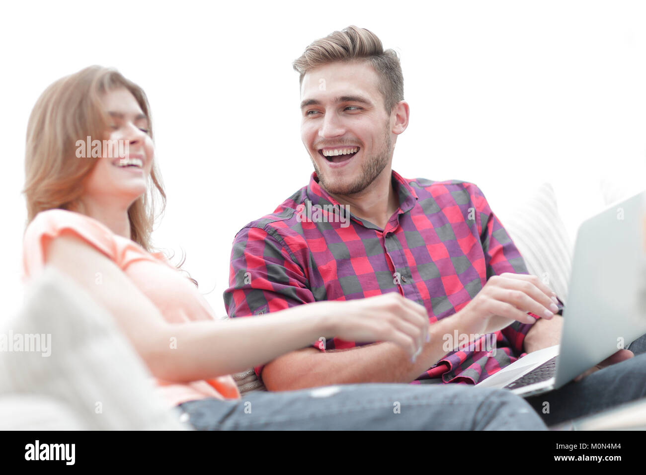 young man and his girlfriend cheering for their team while sitting on ...