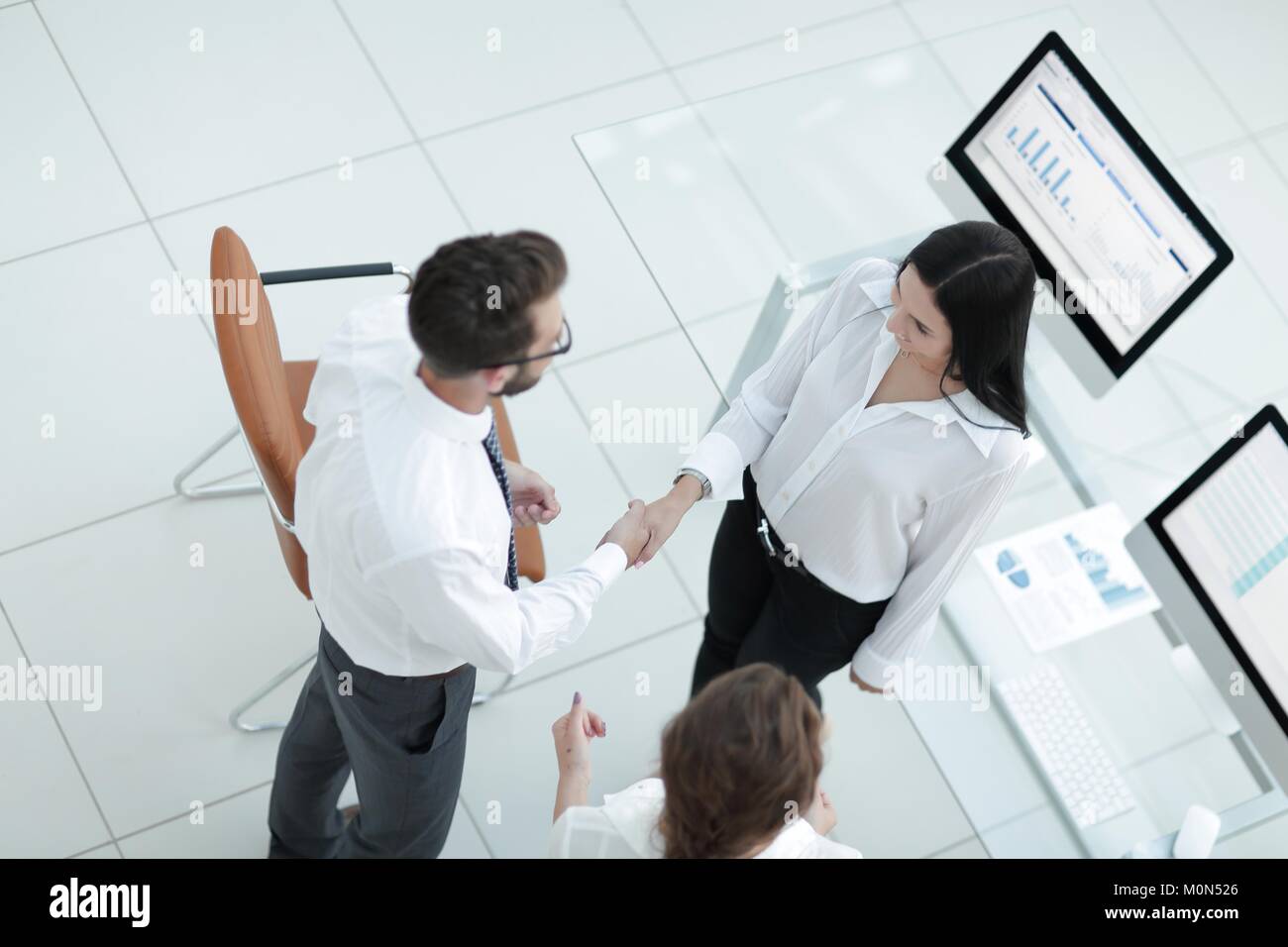 handshake manager and employee near the workplace Stock Photo - Alamy