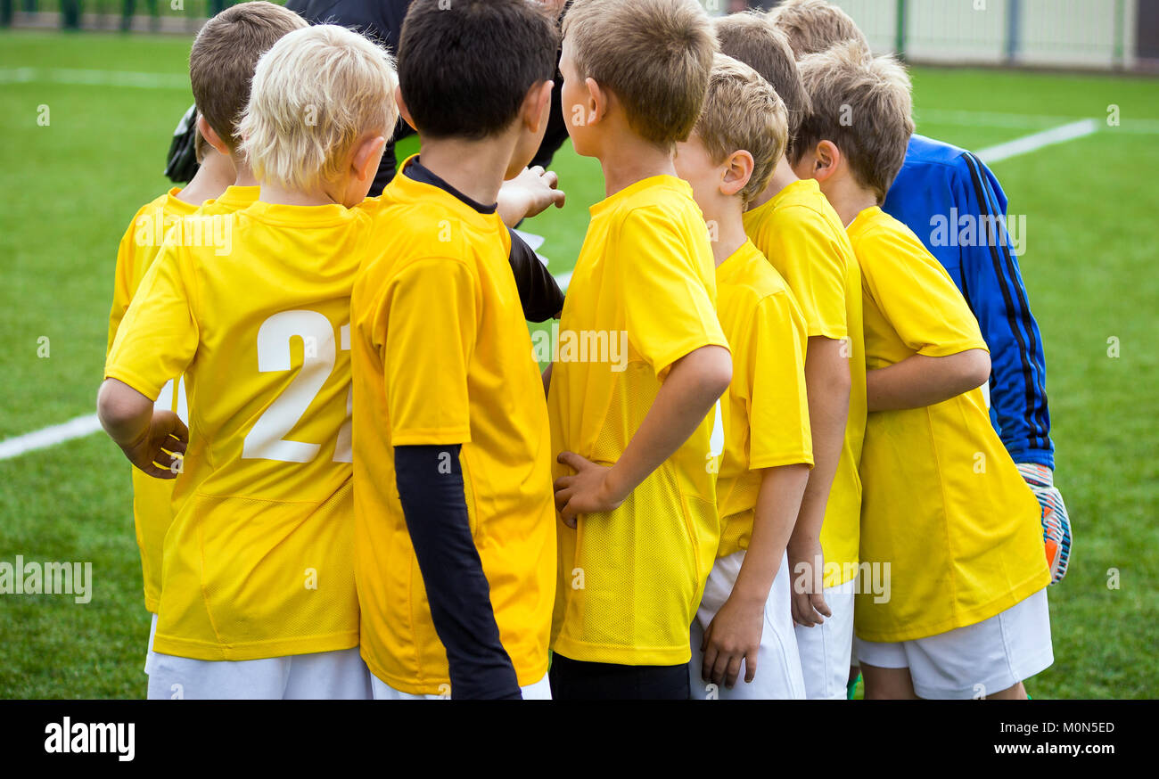 Young football soccer players with coach. Coach motivate children. Kids ...