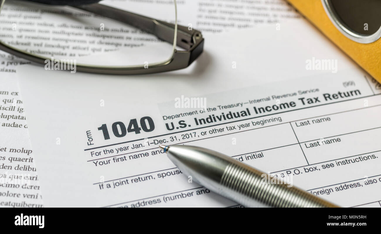 A Tax return form with a pen on a desk Stock Photo - Alamy