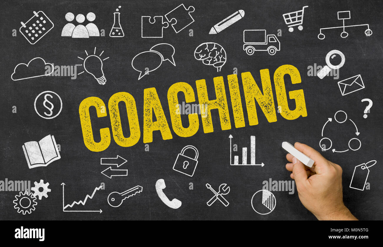 Coaching written on a blackboard with icons Stock Photo - Alamy