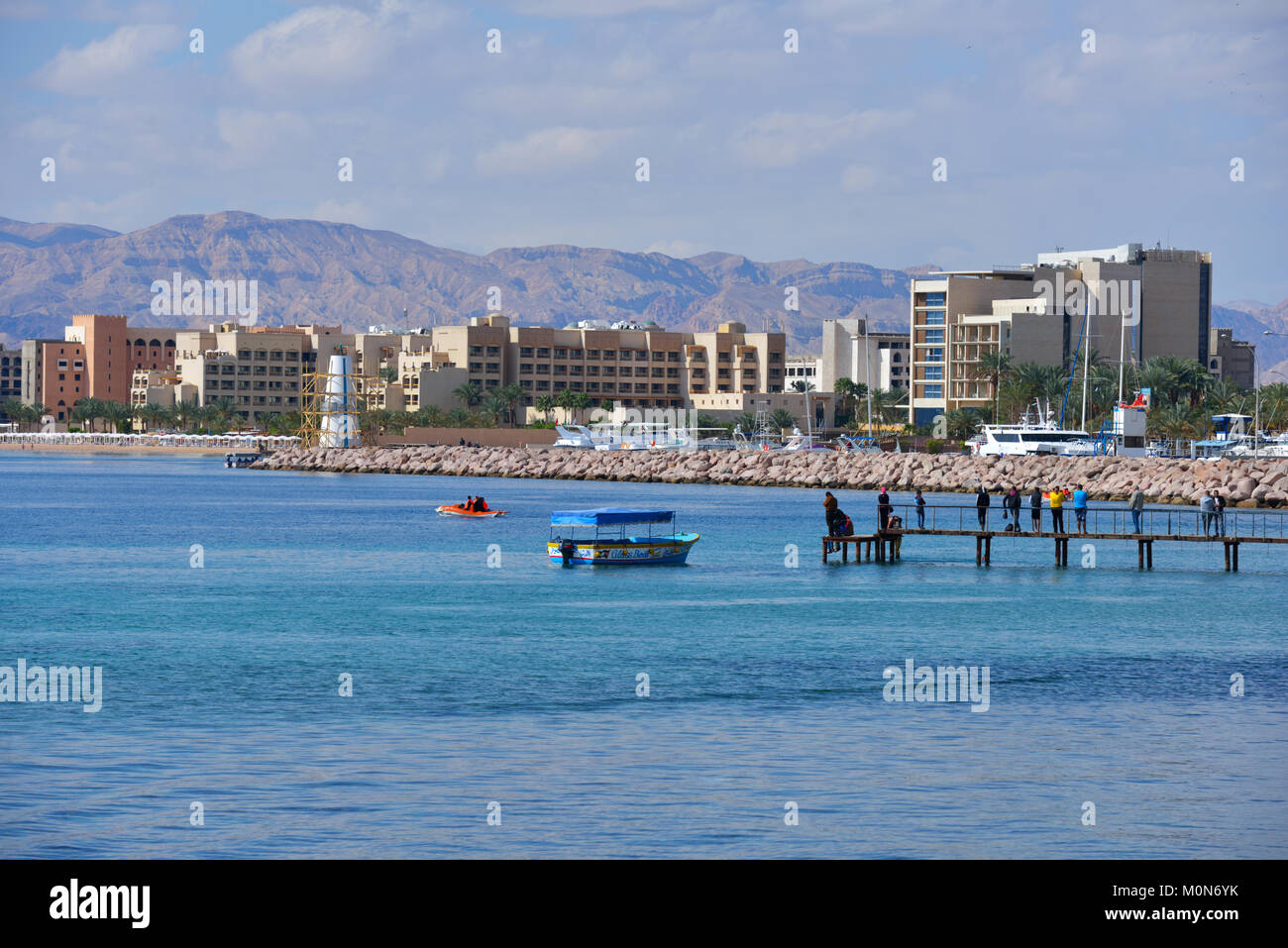 Aqaba, Jordan - March 14, 2014: People on the pier against marina and ...
