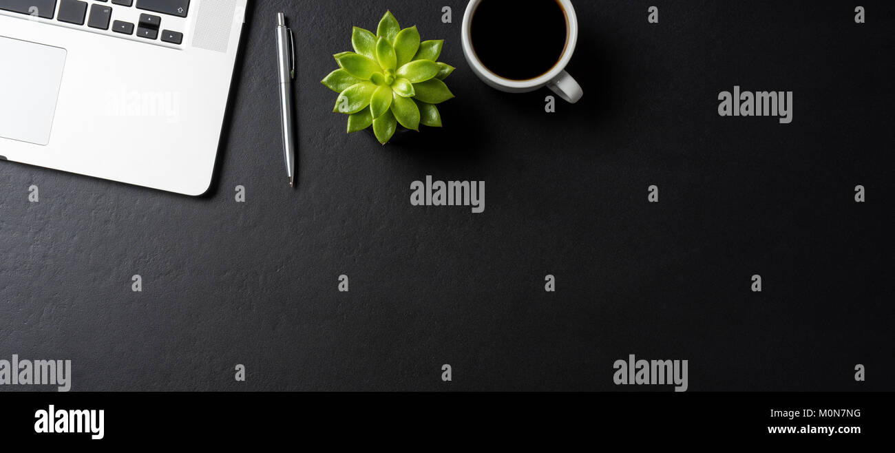 Elegant black office desktop with laptop and accessories. Business ...