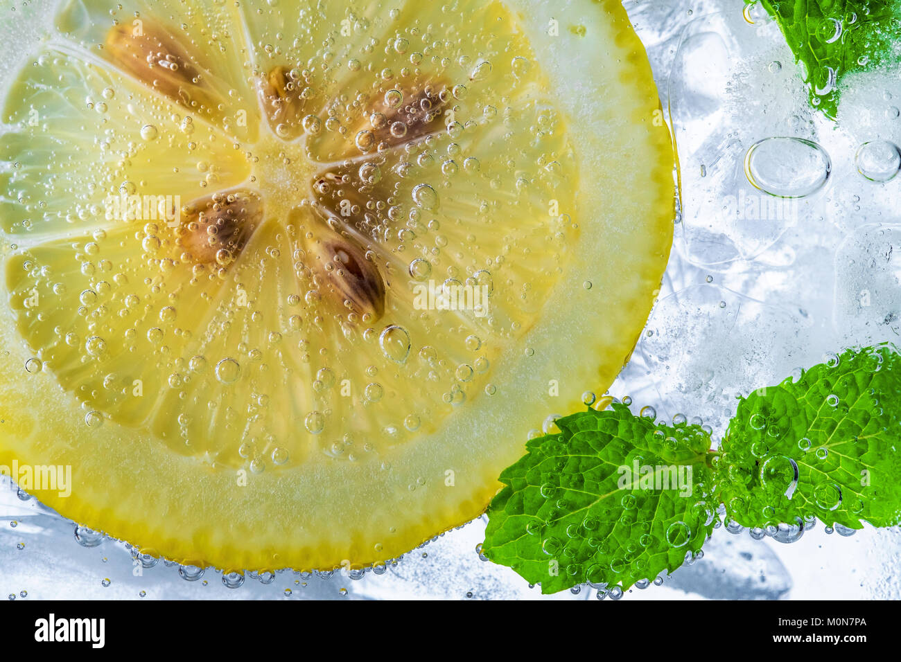 Lemon drop in fizzy sparkling water, juice refreshment Stock Photo - Alamy