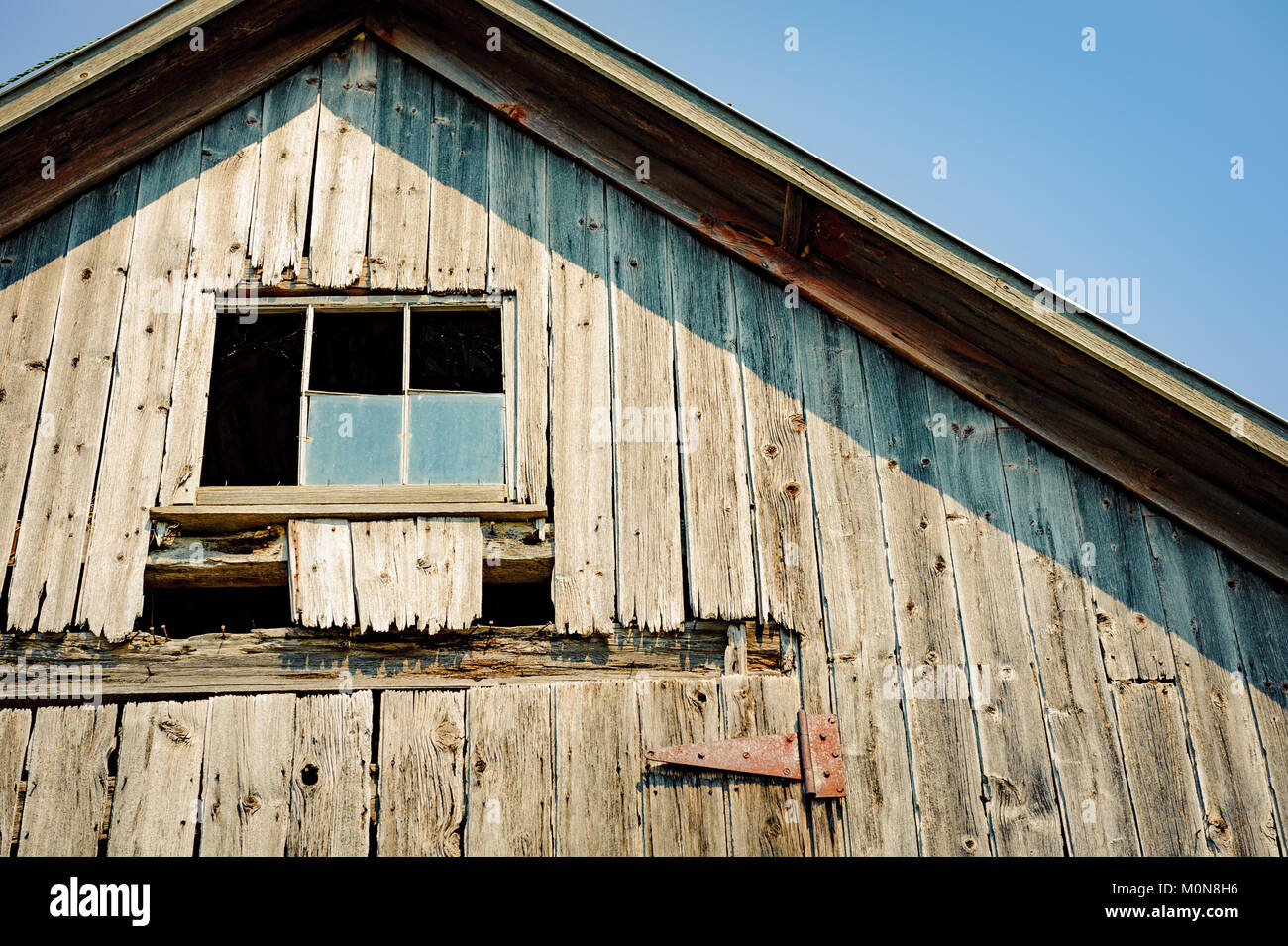 A gable of an old barn in a blue sky Stock Photo - Alamy