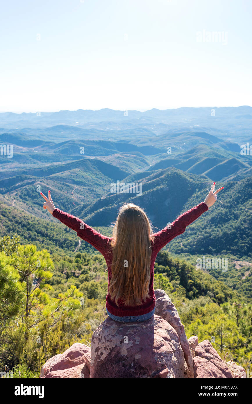Beautiful women showing peace sign while enjoying mountains landscape ...