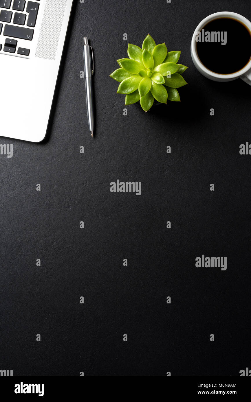 Elegant black office desktop with laptop and accessories. Business ...