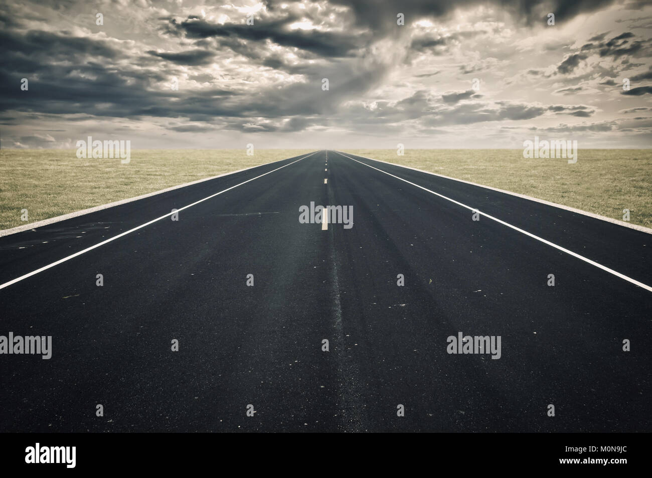 Road perspective, dark clouds, crisis concept Stock Photo - Alamy