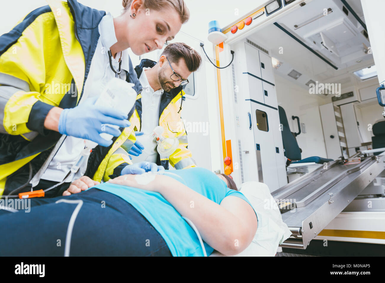Doctors with infusion and oxygen taking care of woman Stock Photo - Alamy