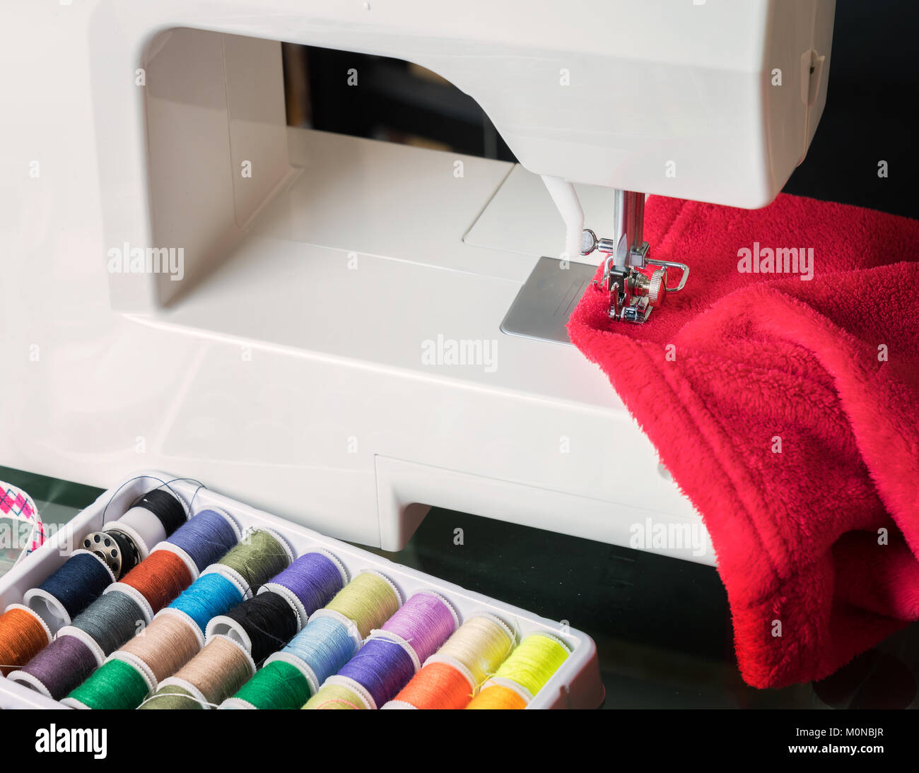 sewing machine and red cloth, sewing process in the phase of ...