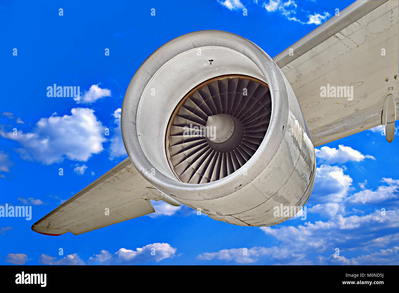 Aviation engine under a airplane wing on the blue sky background Stock ...