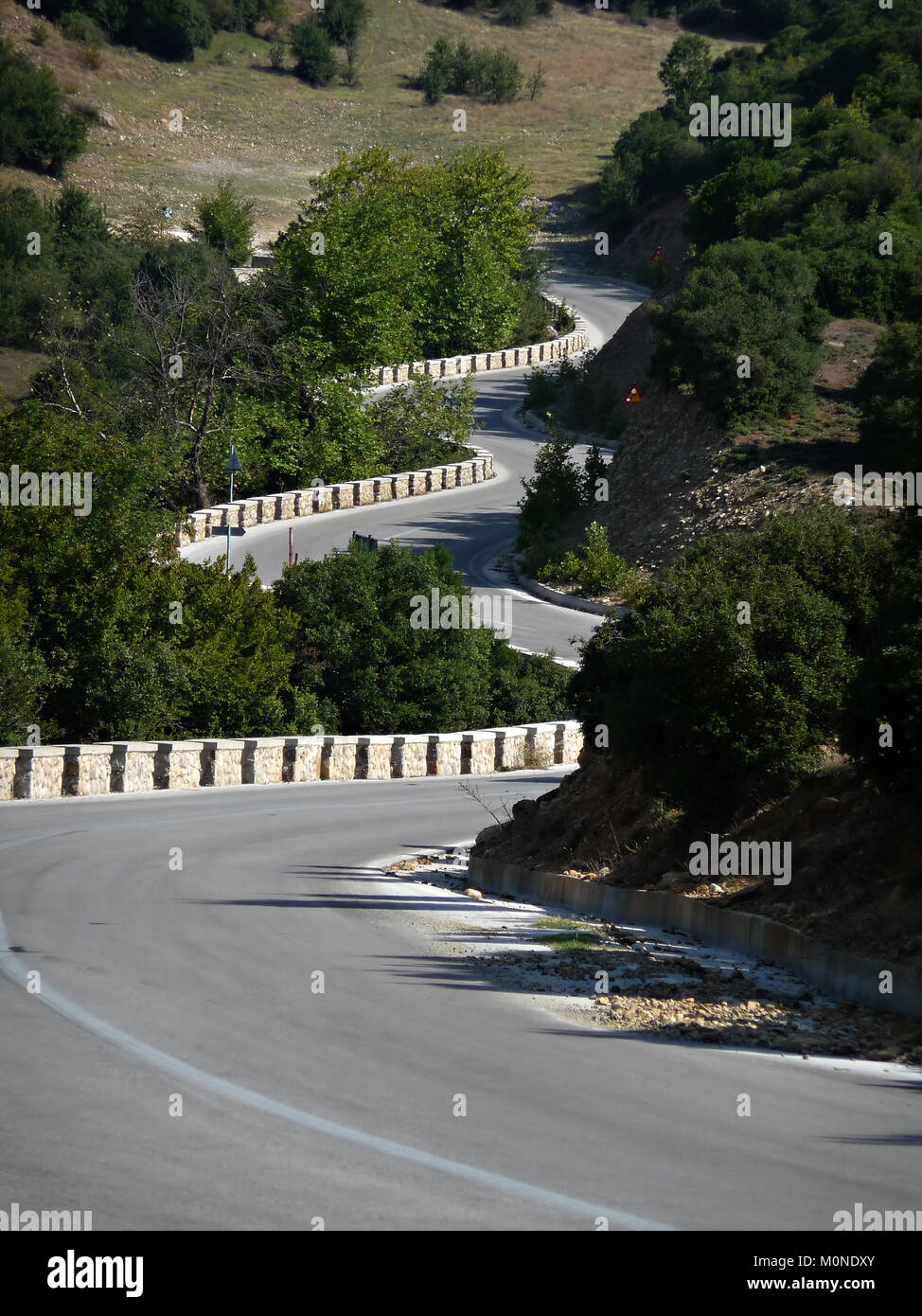 A curved road through a national park at sunny summer day Stock Photo ...