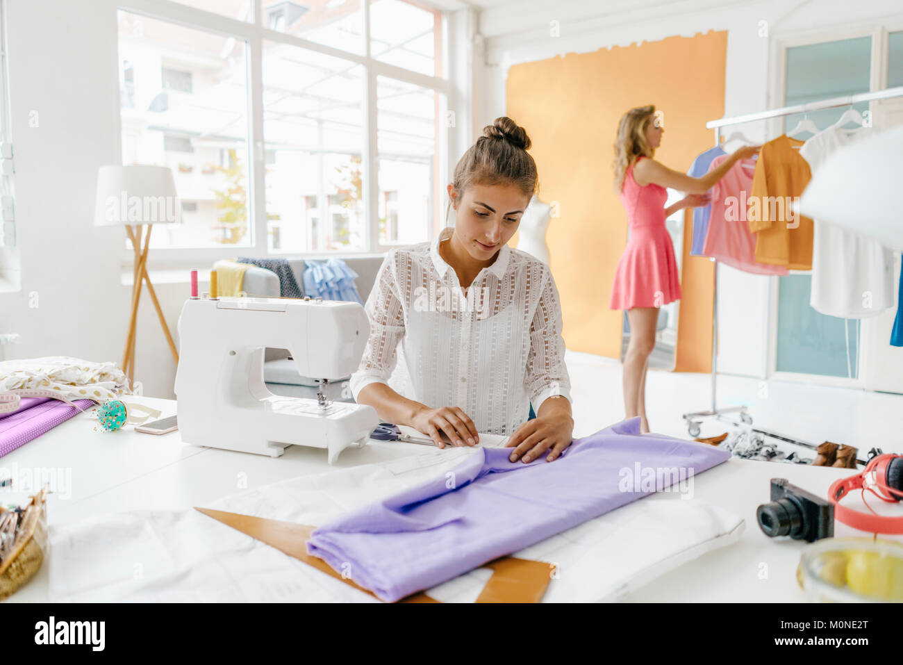 Two young women in fashion studio Stock Photo - Alamy