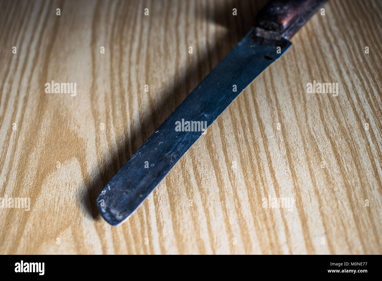 an old and used sharp kitchen knife fall down on a wooden floor Stock ...