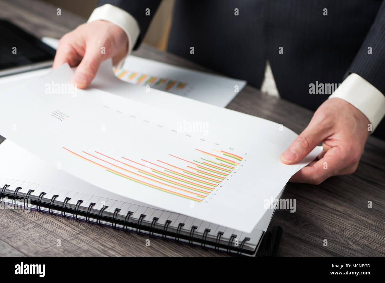 Business man checking bar chart Stock Photo - Alamy