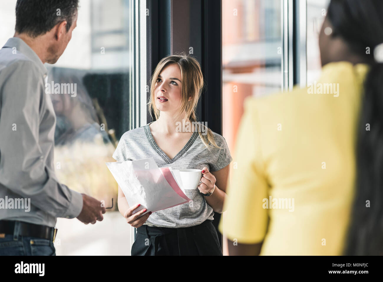 Business people talking at the window in office Stock Photo - Alamy