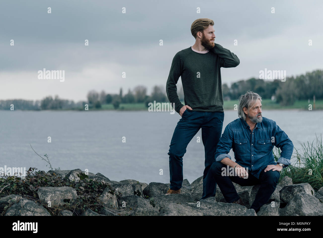 Father and son spending time together outdoors, taking a break, sitting ...