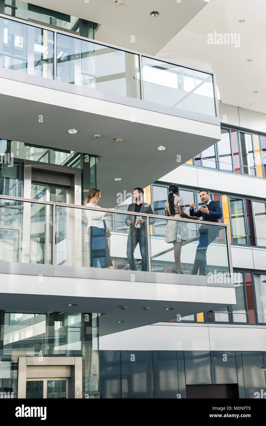 Business people talking on office floor Stock Photo - Alamy