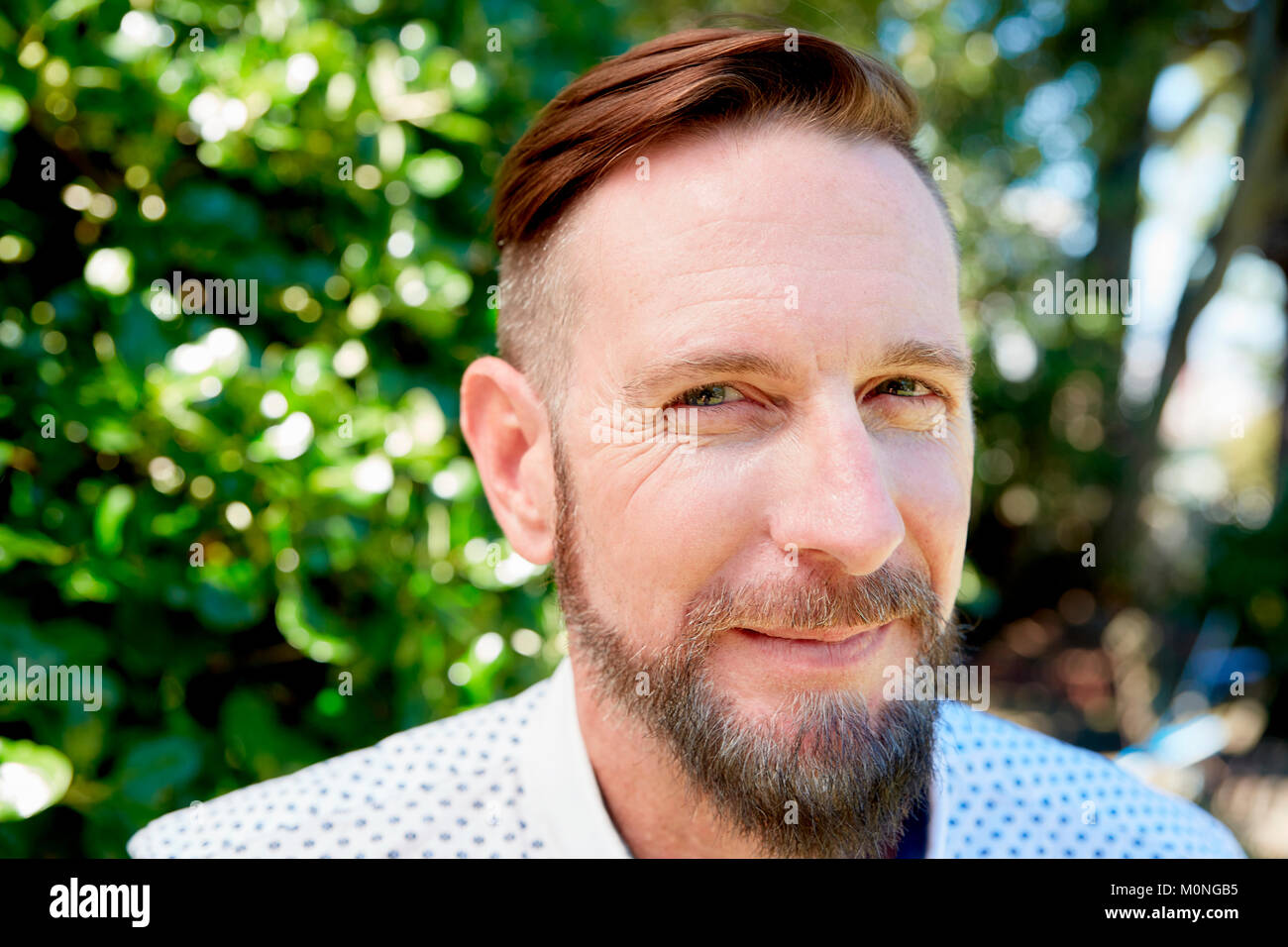 Portrait of smiling bearded man outdoors Stock Photo - Alamy