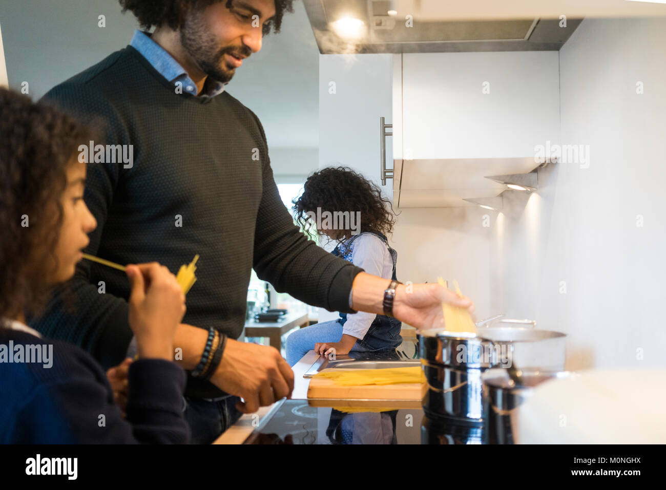 Father and daughter in kitchen preparing spaghetti Stock Photo - Alamy