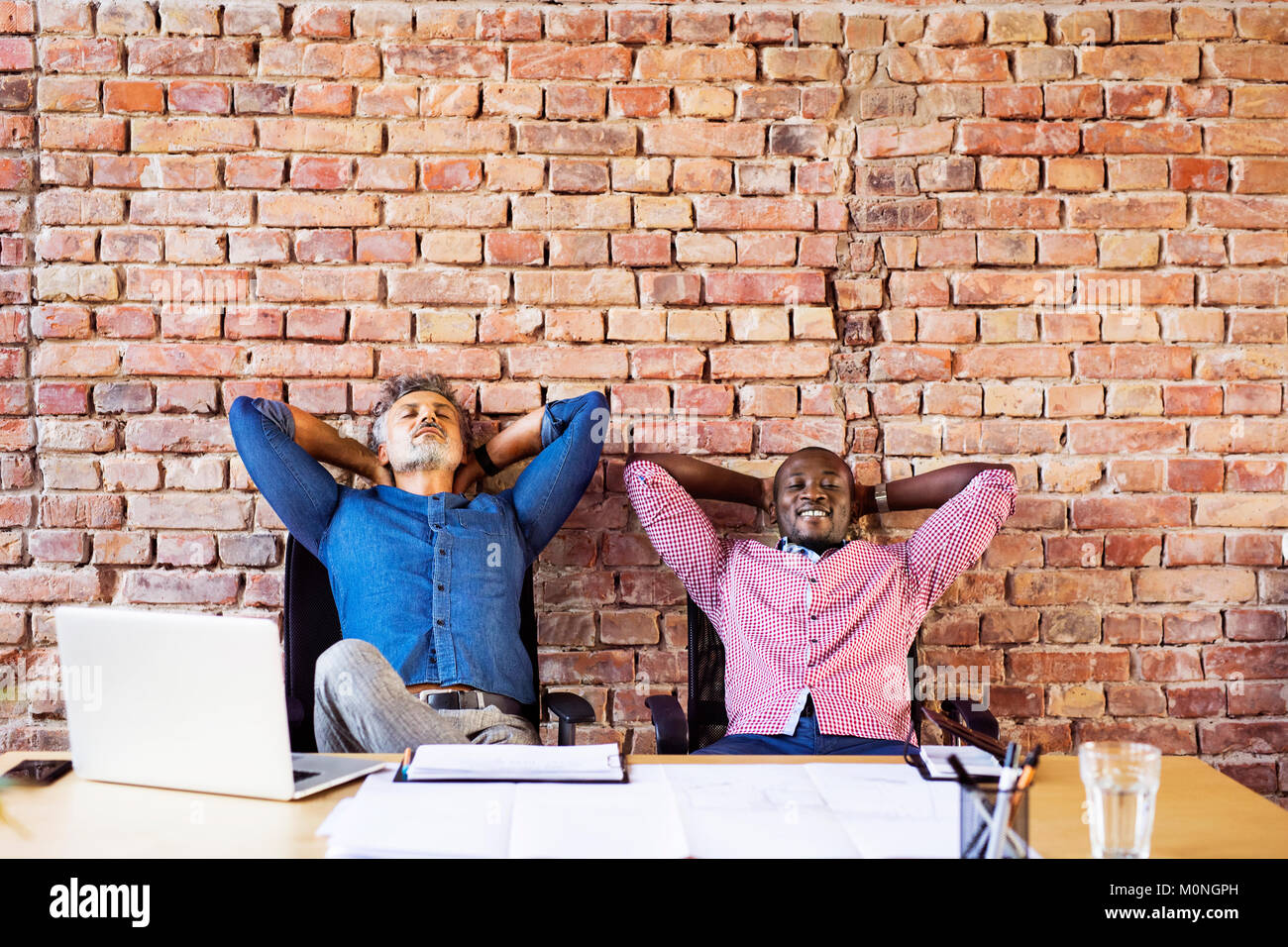 wo colleagues sitting relaxed in office, taking a break Stock Photo - Alamy
