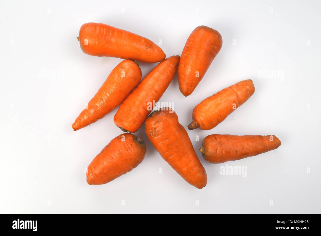 Fresh rustic carrots just dug from the ground Stock Photo - Alamy