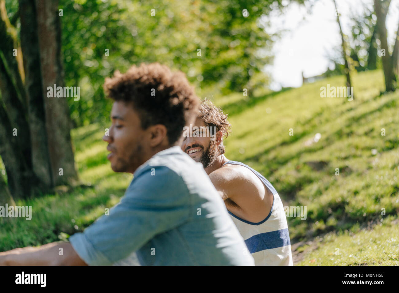 Two friends relaxing in a park Stock Photo - Alamy