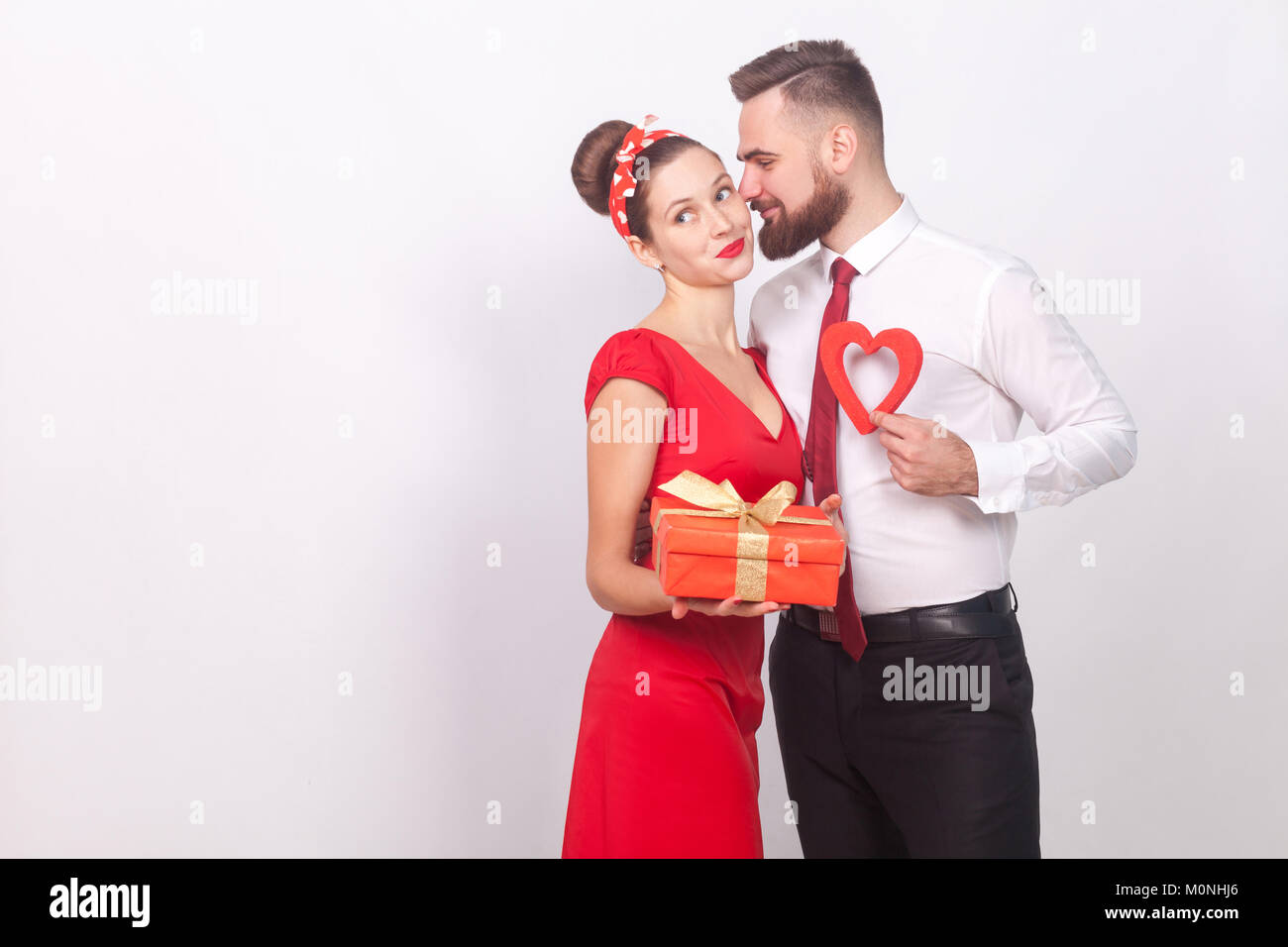 Man present gift box his love in valentine's day. Indoor, studio shot ...