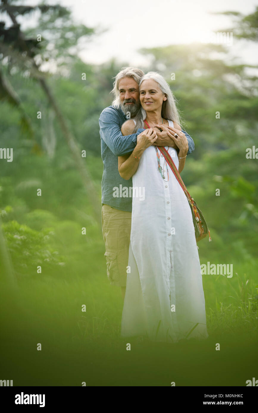Handsome senior couple hugging in tropical landscape Stock Photo - Alamy