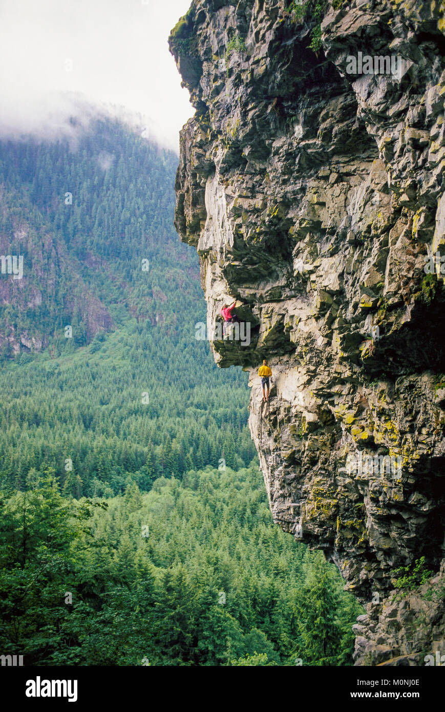 Two men climbing an overhanging cliff up the North Fork of the ...