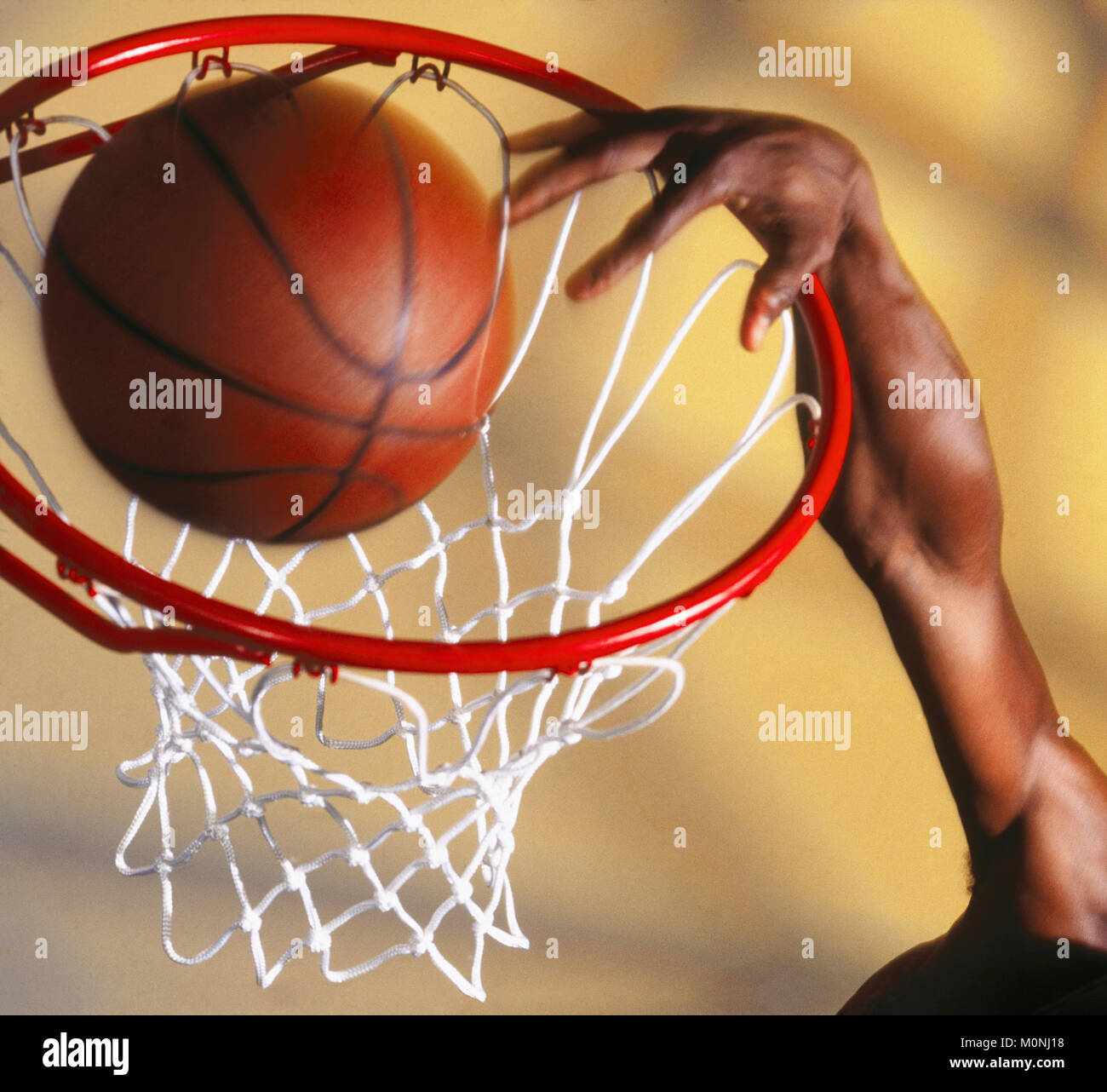 Basketball player dunking ball into hoop Stock Photo - Alamy