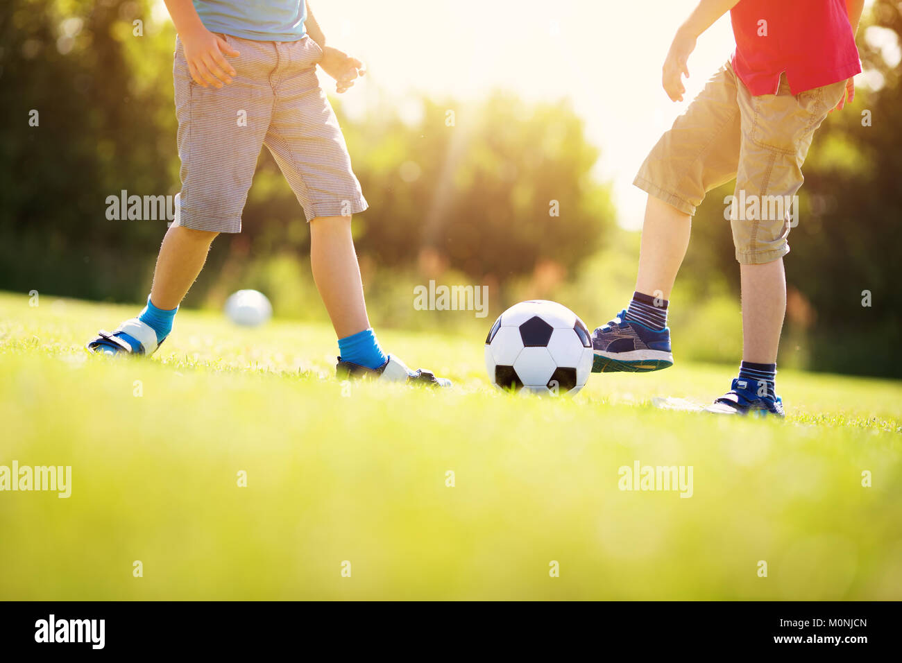 Boys play football on field hi-res stock photography and images - Alamy