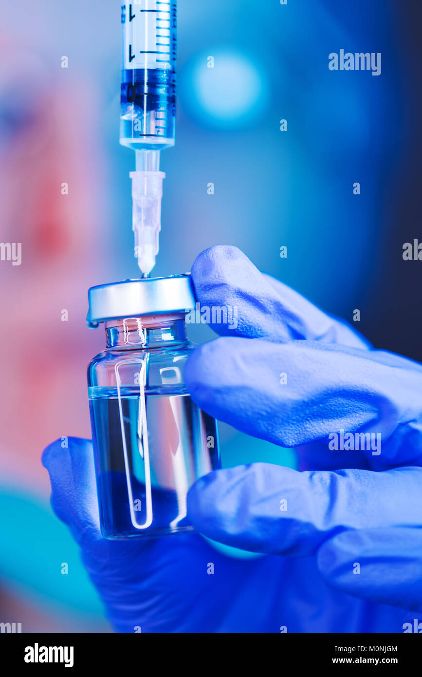 Doctor with syringe in clinic hi-res stock photography and images - Alamy