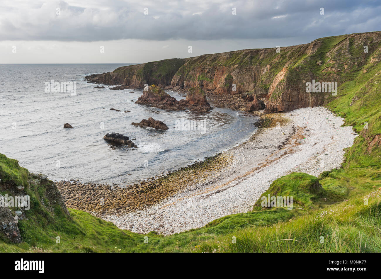 Cliffs, sea stacks, shingle beach and cove at Bloody Foreland, at the ...