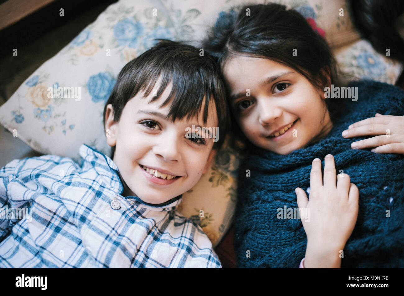 Two lying laughing brothers hi-res stock photography and images - Alamy