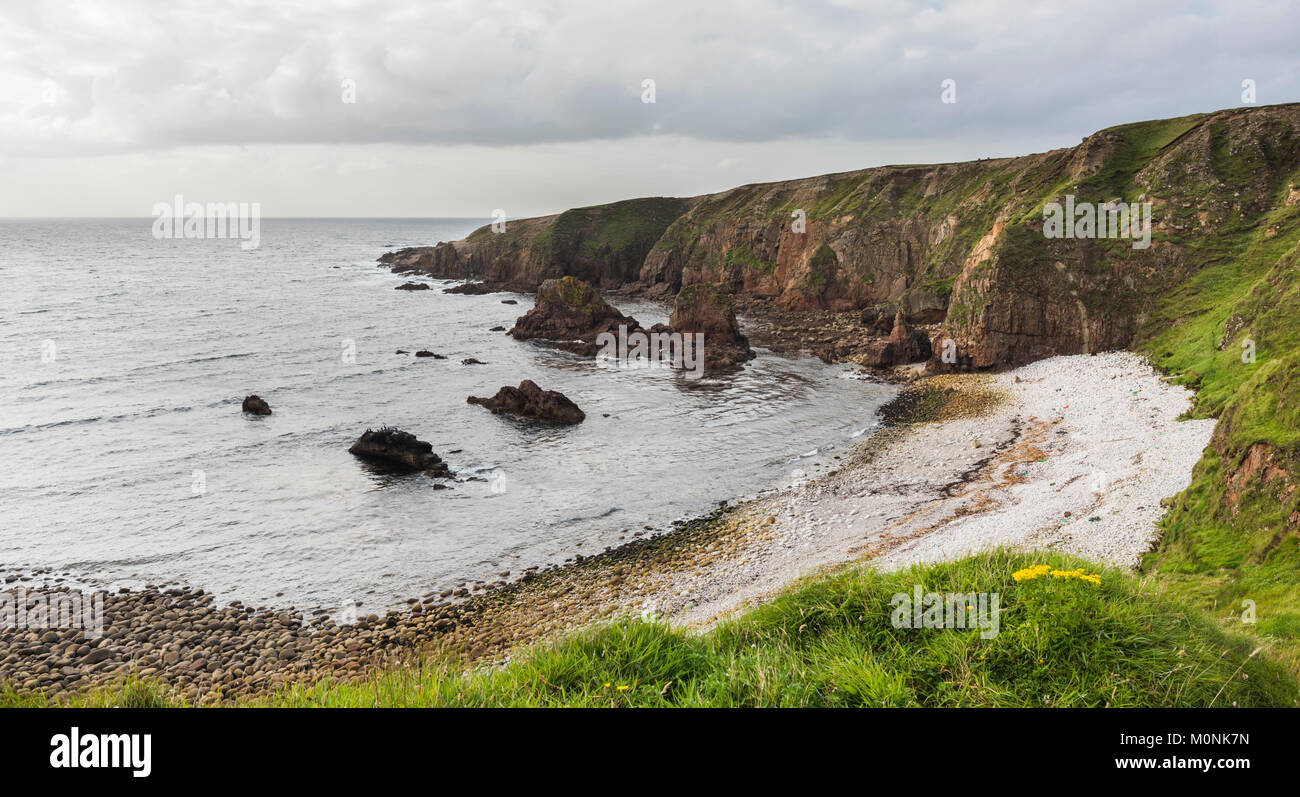 Cliffs, sea stacks, shingle beach and cove at Bloody Foreland, at the ...