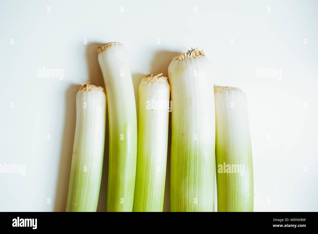 still life of vegetable leeks on white background Stock Photo - Alamy