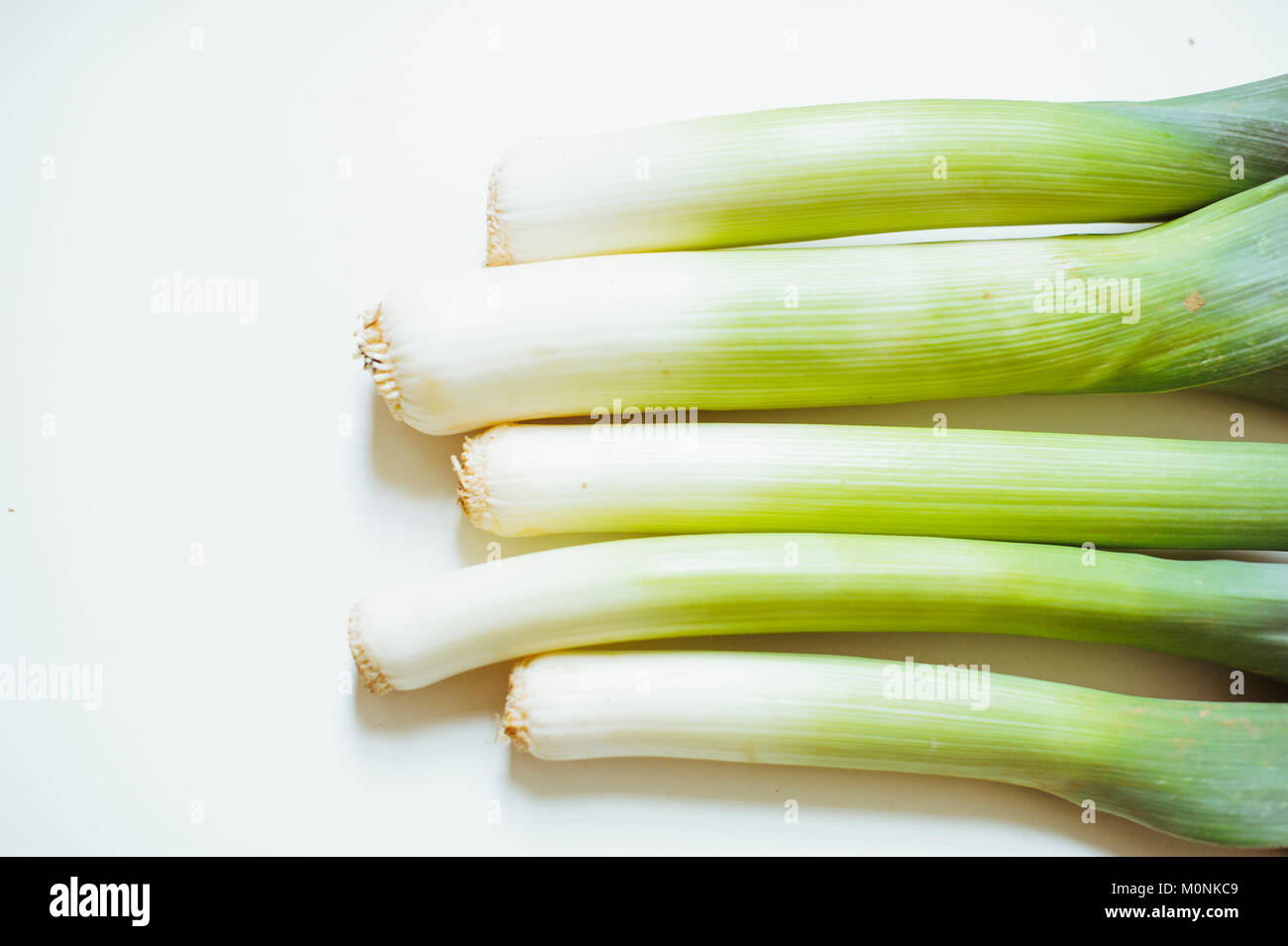 still life of vegetable leeks on white background Stock Photo - Alamy